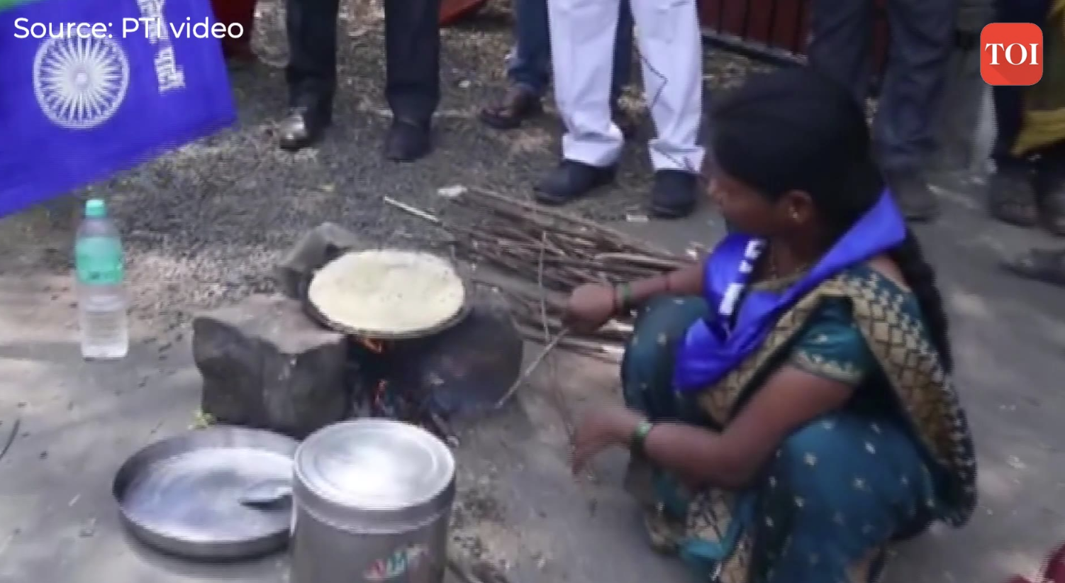 Women in Beed protest against LPG price hike by making rotis on a chulha