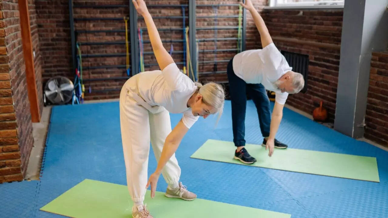 5 stretching exercises to do before walking - Times of India