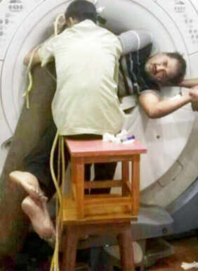 Two stuck to MRI machine for 4 hrs