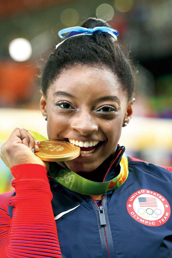 Why Olympics winners bite their medals - Times of India