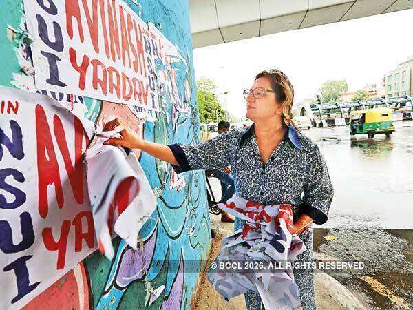Students, artists remove DUSU election posters from graffitied wall at ...