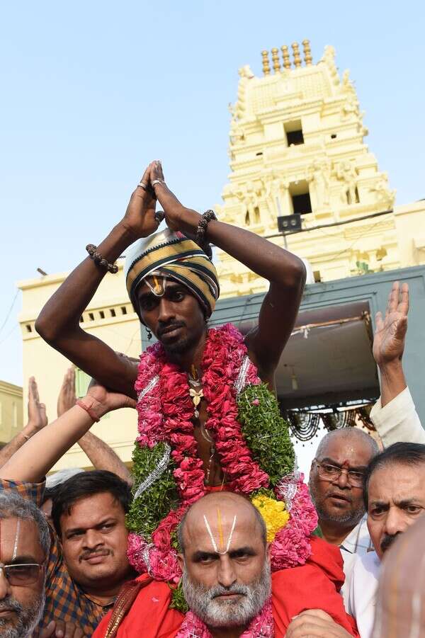 Hundreds cheer on as Chilkur Balaji priest carries a Dalit devotee on his shoulders into the ...