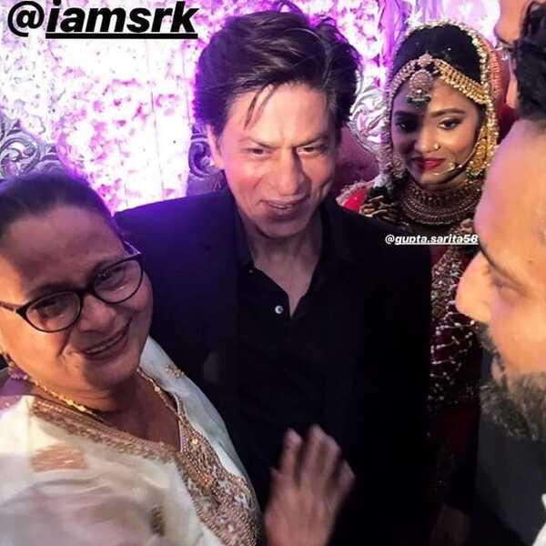 Shah Rukh Khan happily poses for pictures as he attends a wedding; check out the photos here ...