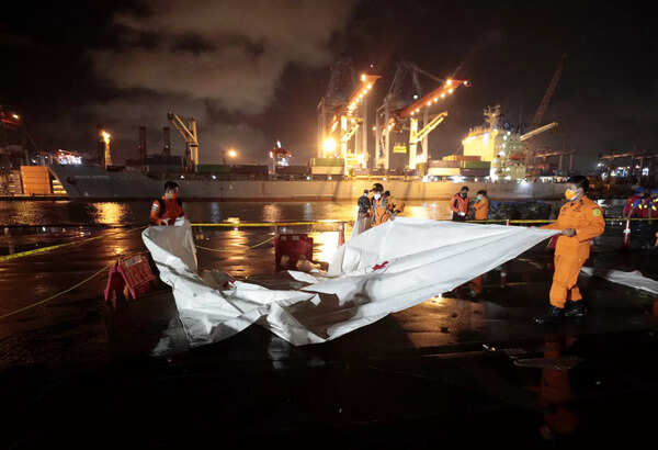 Indonesia plane crash: Body parts, debris found from Java Sea - Times ...