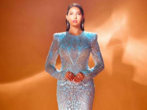 Nora Fatehi flaunts her hourglass figure in a body-hugging golden dress ...