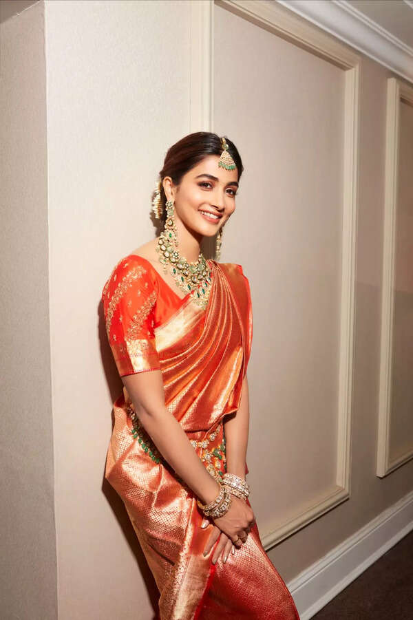 In photos: Pooja Hegde radiates elegance in orange at her brother’s ...