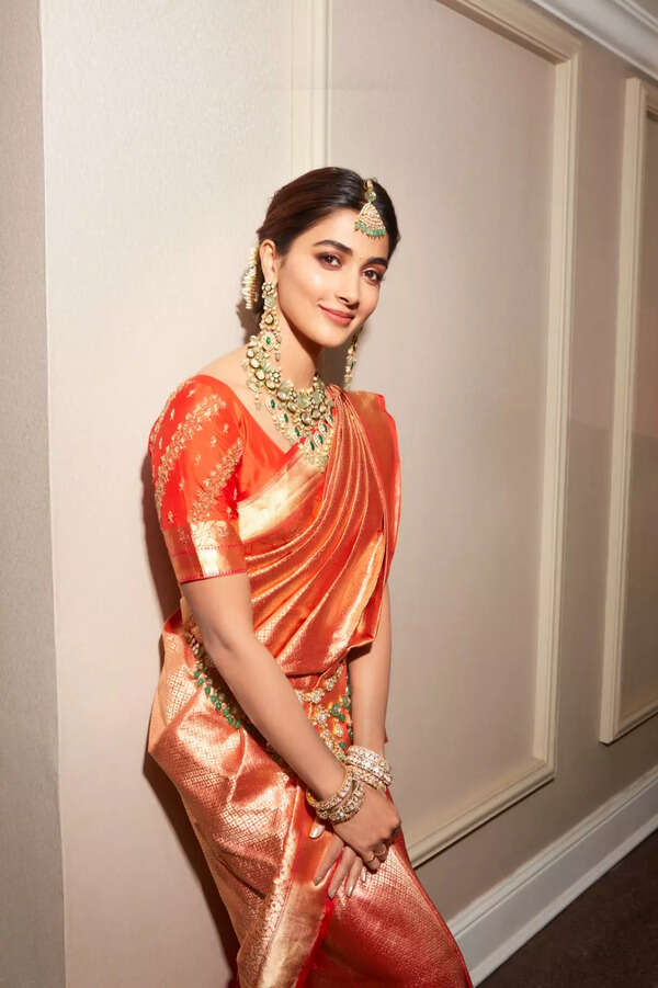 In photos: Pooja Hegde radiates elegance in orange at her brother’s ...