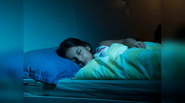 Why do kids move around on the bed in their sleep?
