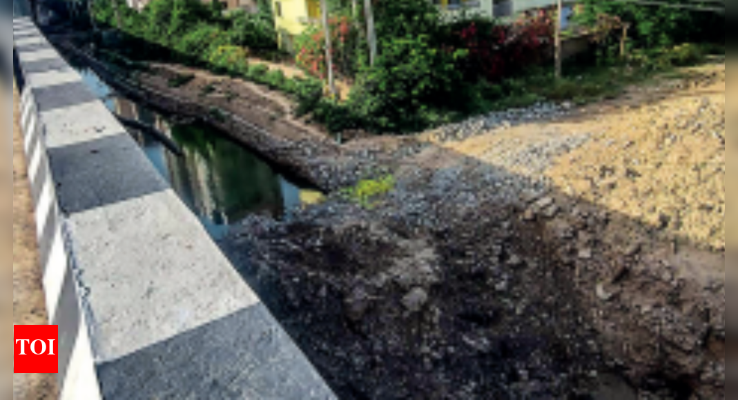 Service road closed 2 years back to build drain; work still not over ...