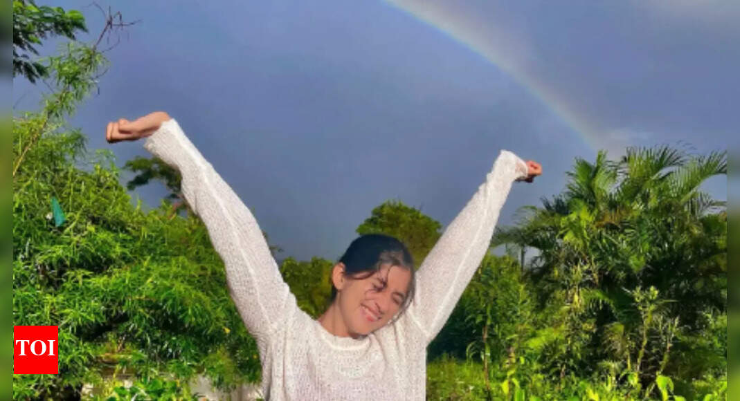 Deeksha Joshi strikes a pose against a stunning rainbow backdrop ...