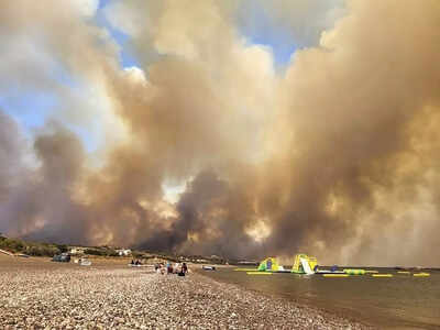 Tourists flee Greek island Rhodes wildfire, thousands evacuated - Times ...