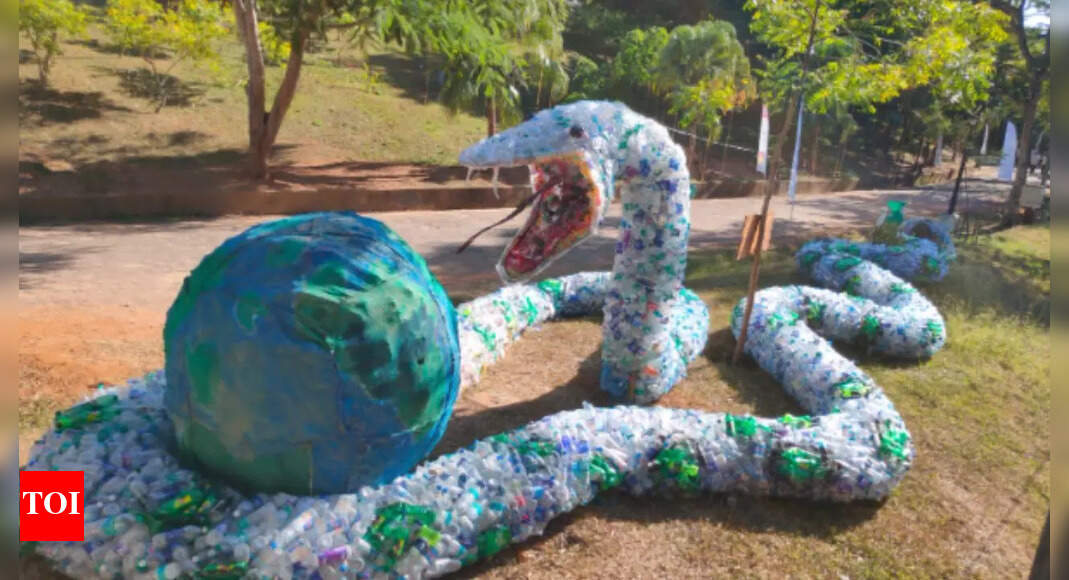 90-foot-long snake about to swallow globe — installation art made out ...