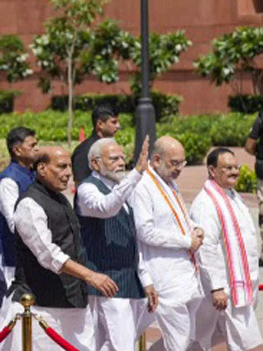 PM Narendra Modi walks to new Parliament building with cabinet ...