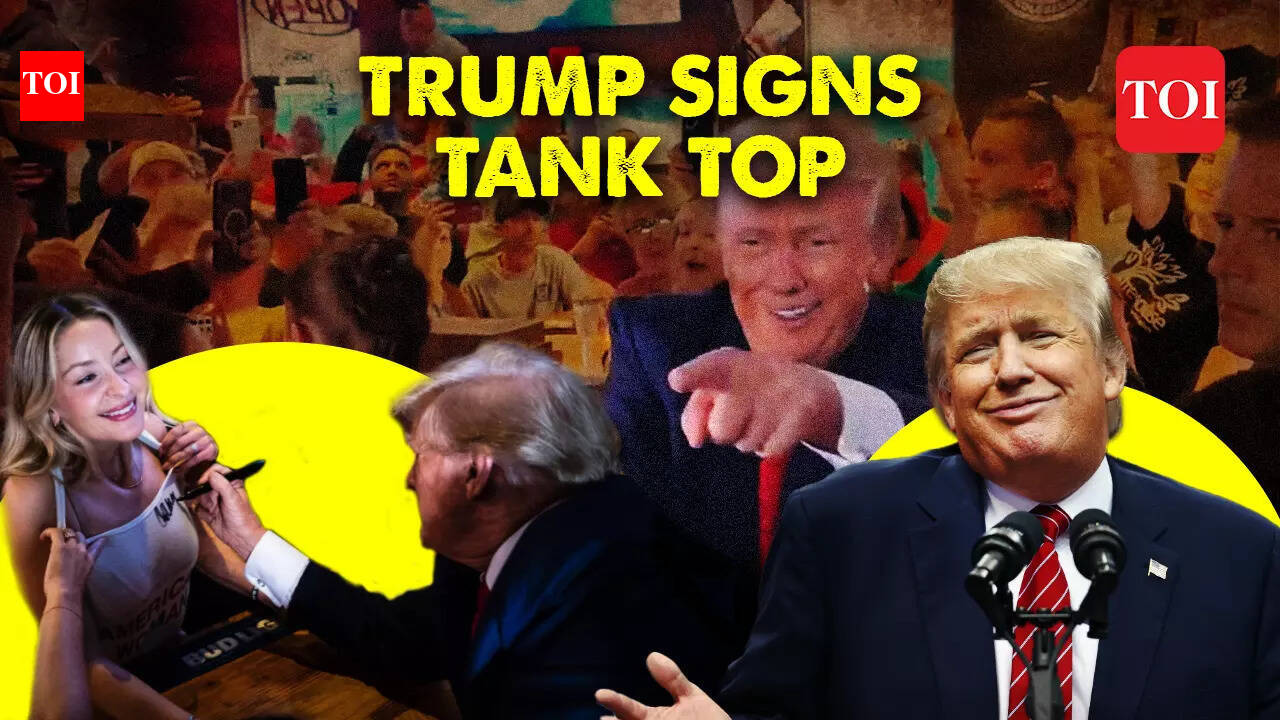 Watch: Donald Trump distributes pizzas, signs bartender's tank top in Iowa