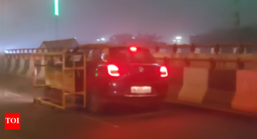 Viral video: Car drags Delhi Police barricade on major flyover! - Times ...
