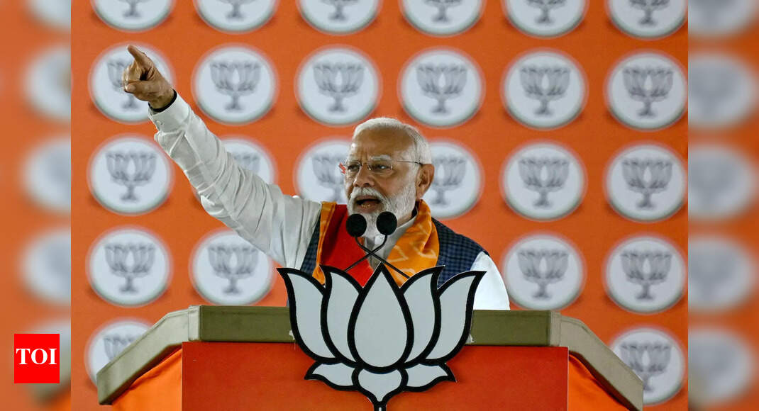 PM Modi pauses poll speech, helps divyang women get seated | India News ... PM Modi pauses poll speech, helps divyang women get seated | India News ...
