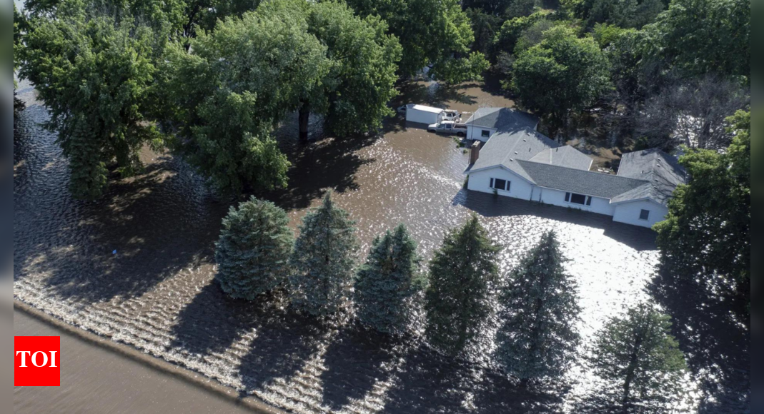Midwest flooding collapses a rail bridge, forces evacuations and kills ...