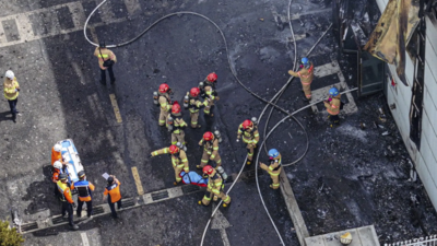 South Korean rescuers search burned factory after a blaze killed 22 ...