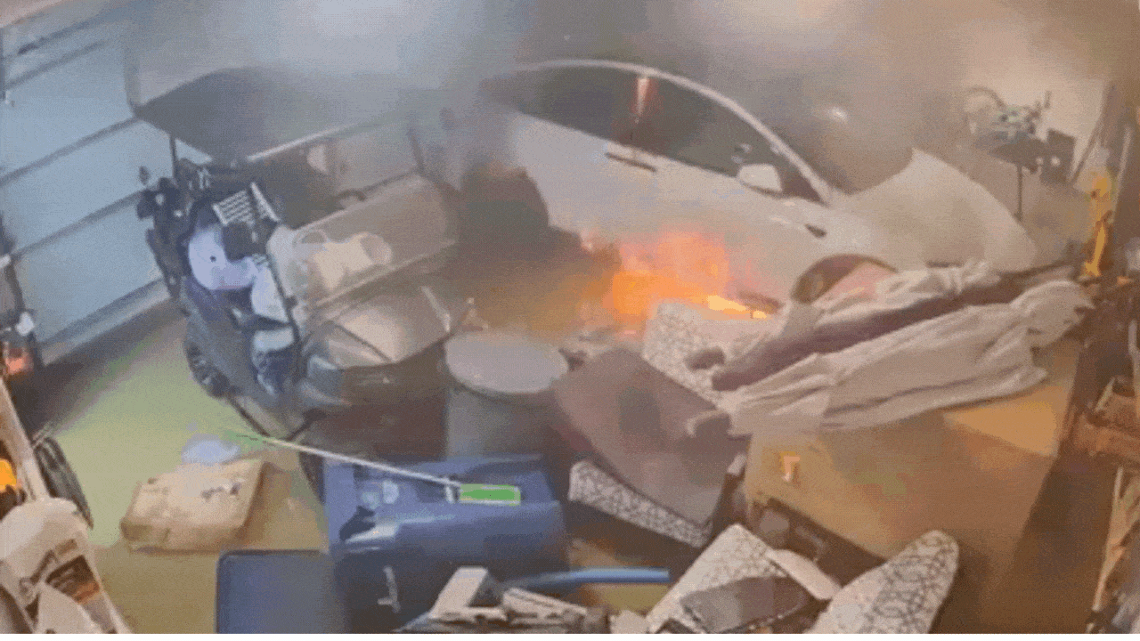 Watch: Tesla catches fire in garage flooded in Florida following ...
