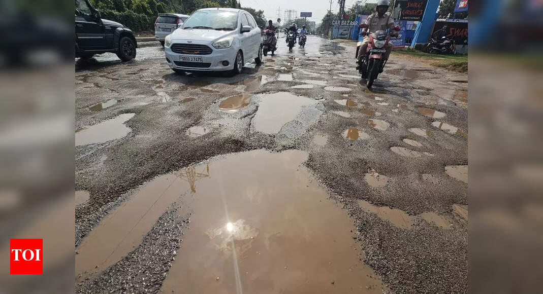 Commuters, patients struggle to cross potholed, drain water-filled road ...