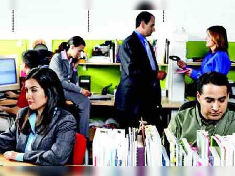 Working in a cramped office - Times of India