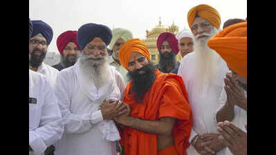 Ramdev visits Golden Temple, donates Rs 1 cr for flood relief ...