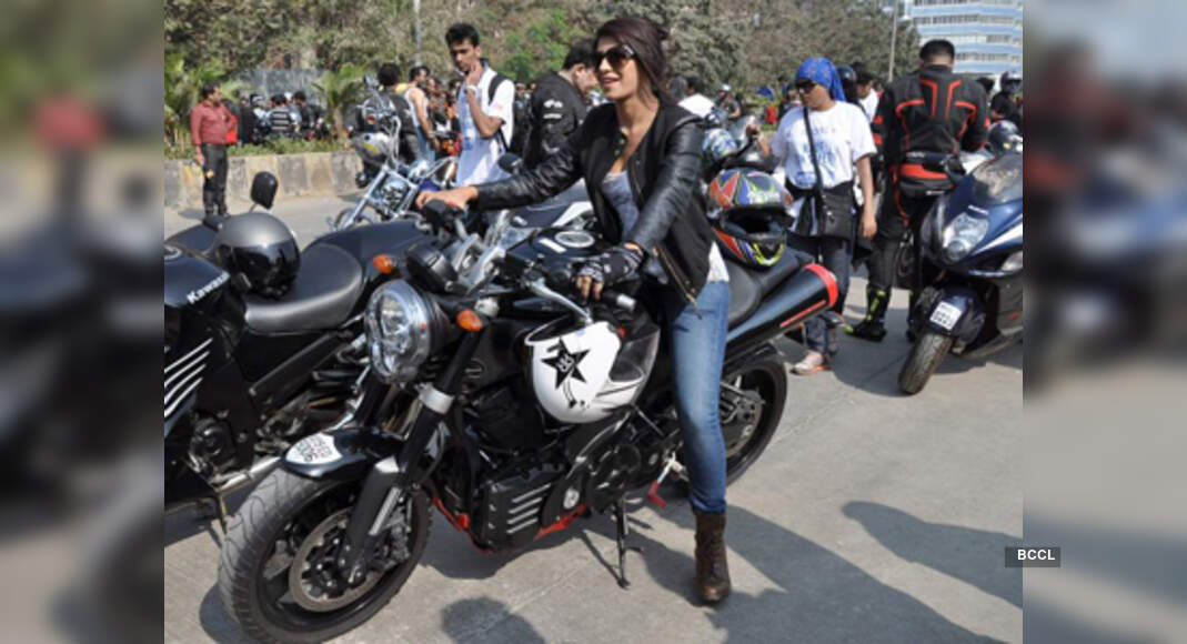 A biker chick poses during a safety drive rally by 600 superbikers at ...