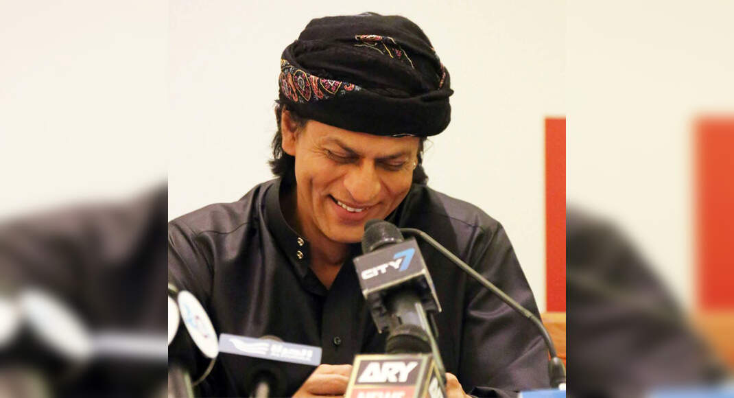 SRK smiles during the press conference of Bollywood film Happy New Year ...