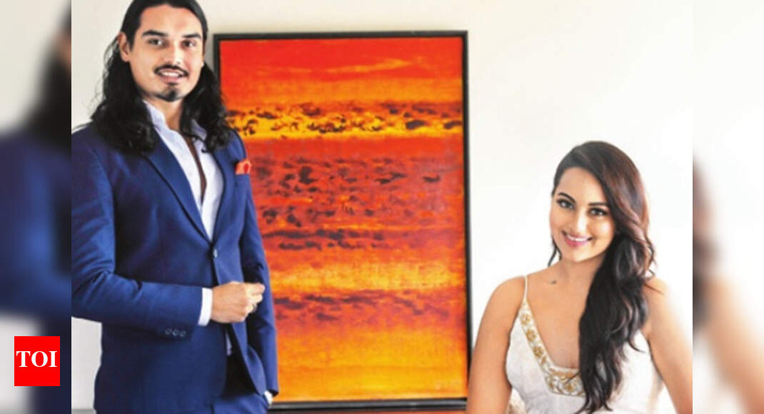Sonakshi Sinha poses with Nicholai Sachdev during an exhibition in ...