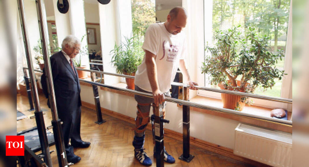 Paralysed man walks again after pioneering surgery - Times of India