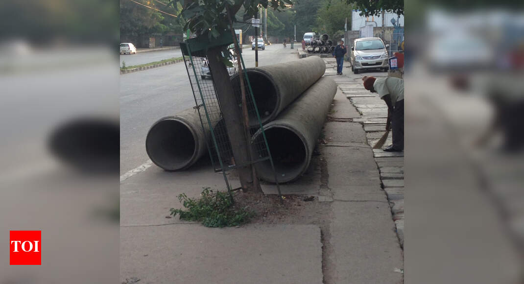 Pipes block footpath on Old Airport Road - Times of India