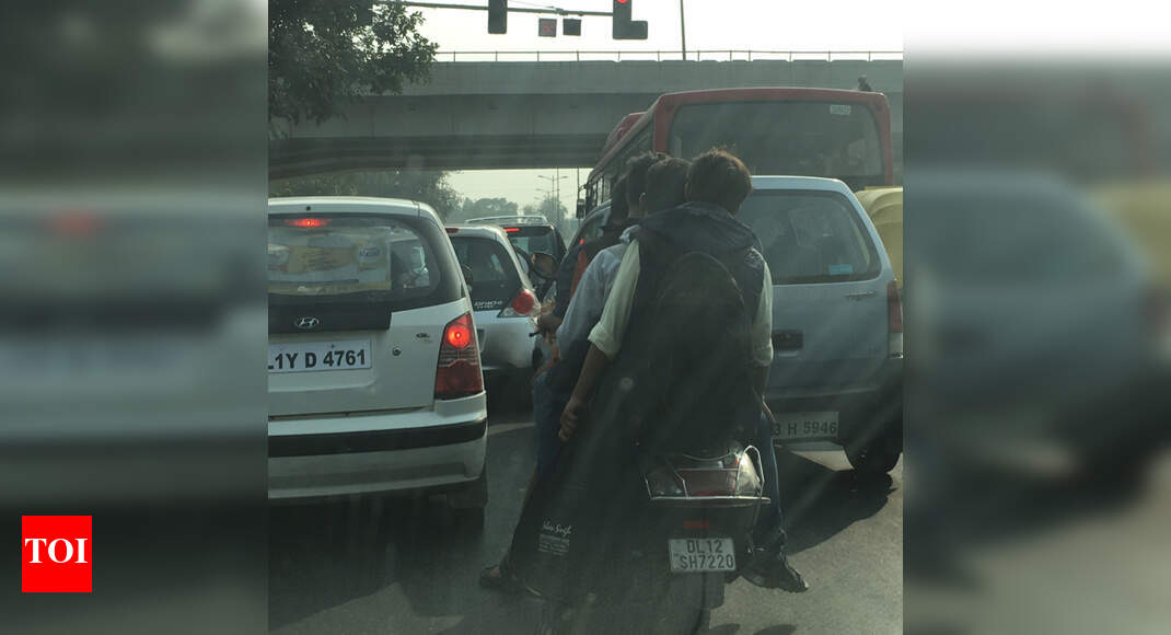 Four helmetless riders on a two-wheeler - Times of India