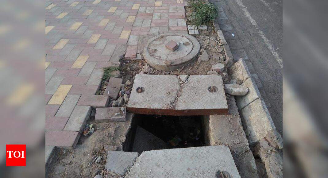 Broken manhole covers on footpath - Times of India