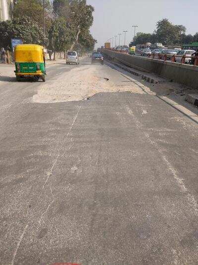 More holes, less road at Nehru Place flyover - Times of India