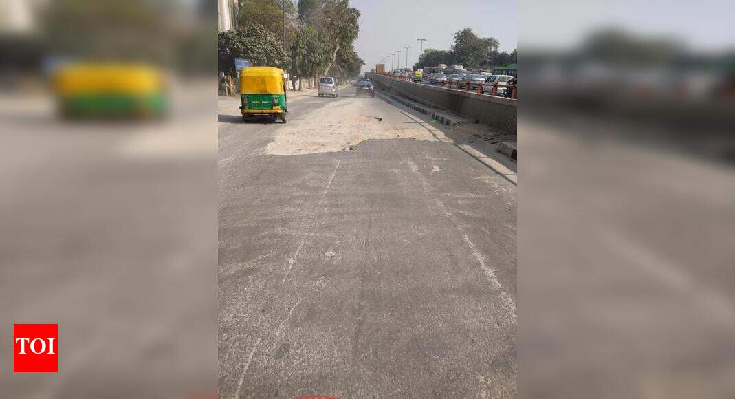 More holes, less road at Nehru Place flyover - Times of India