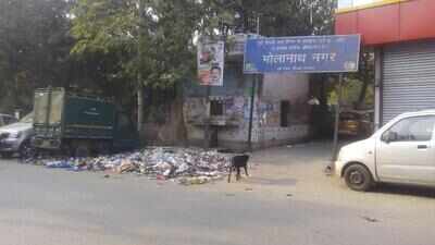 Trash heaps on roadside - Times of India