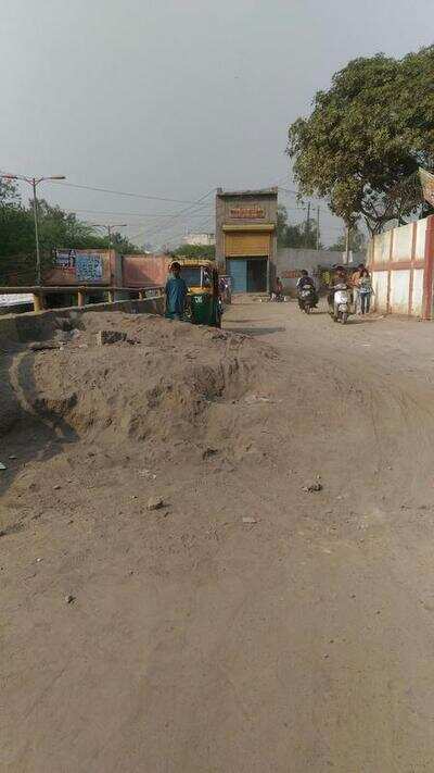 Road dug up, construction material dumped - Times of India