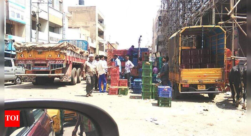 Parked vehicles block traffic on Kalasipalyam road - Times of India