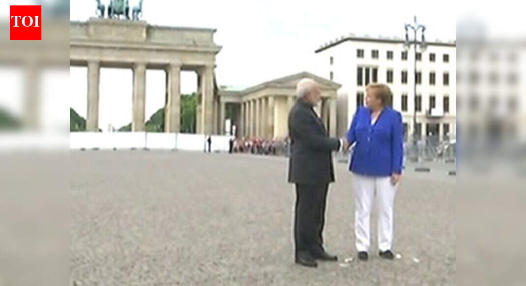 PM Modi, Angela Merkel shake hands in front of Brandenburg Gate