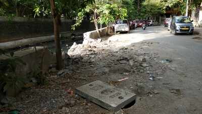 broken nallah wall and Manholes not repaired - Times of India