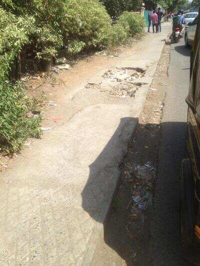 Crumbling footpath - Times of India