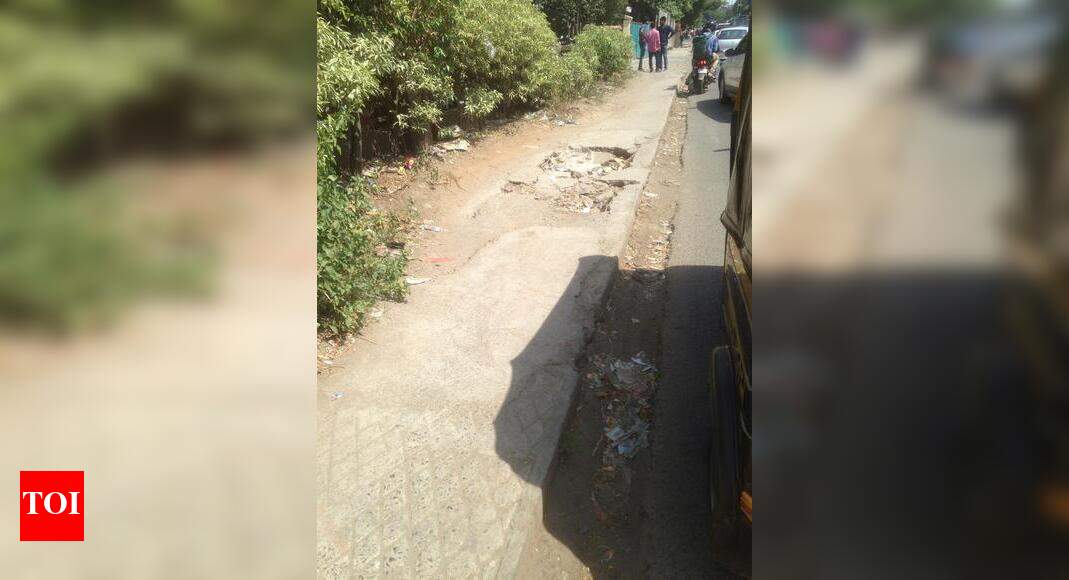 Crumbling footpath - Times of India