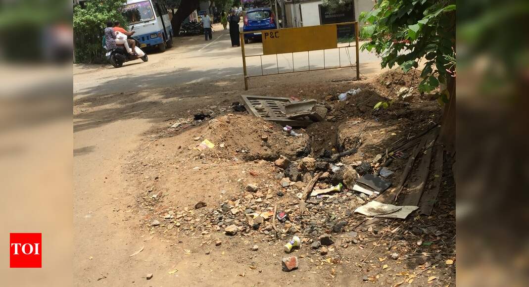 uncovered pits in the middle of road - Times of India