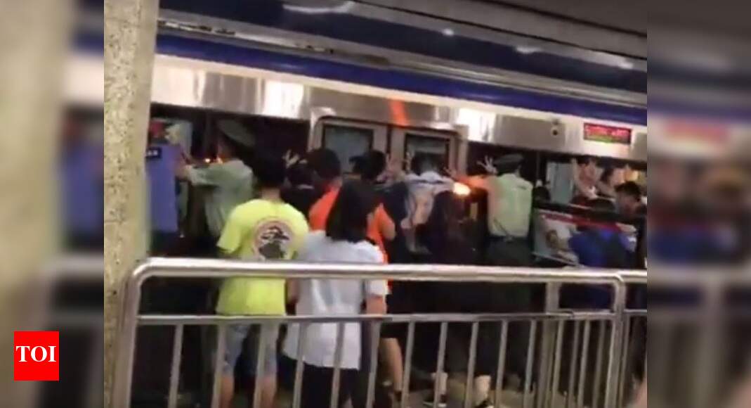 WATCH: Passengers push train to save trapped man in Beijing - Times of ...
