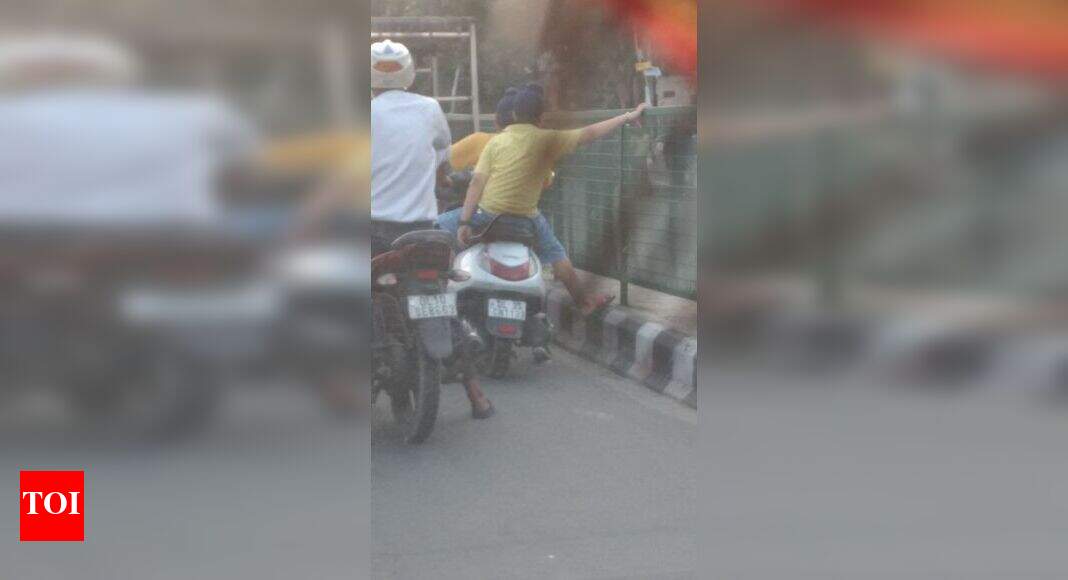 Underage driving and pillion riding on main road - Times of India