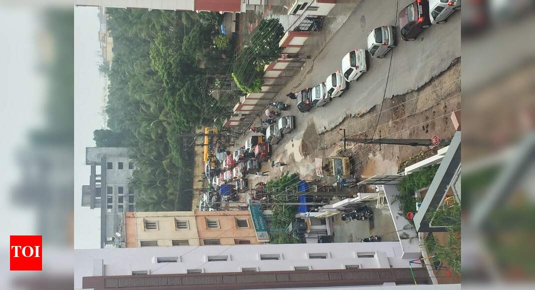 Road dug up and potholes cause traffic jam - Times of India
