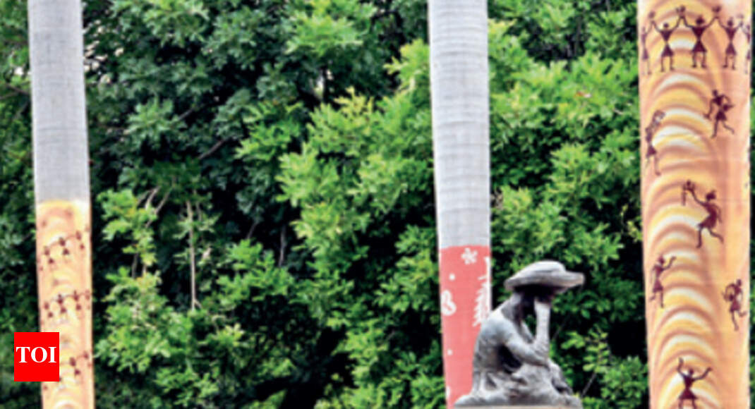 Tribal art adorns tree trunks in parks | Surat News - Times of India