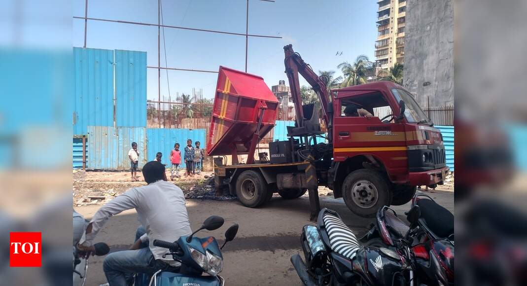 BMC tempo dumping garbage next to a road - Times of India