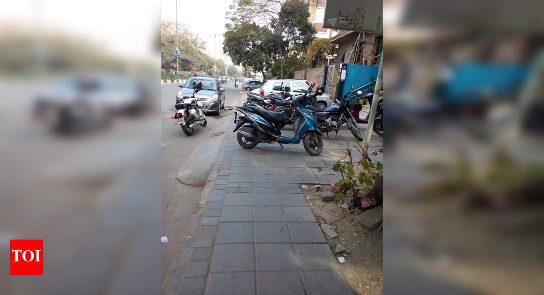 Vehicles parked on footpath - Times of India