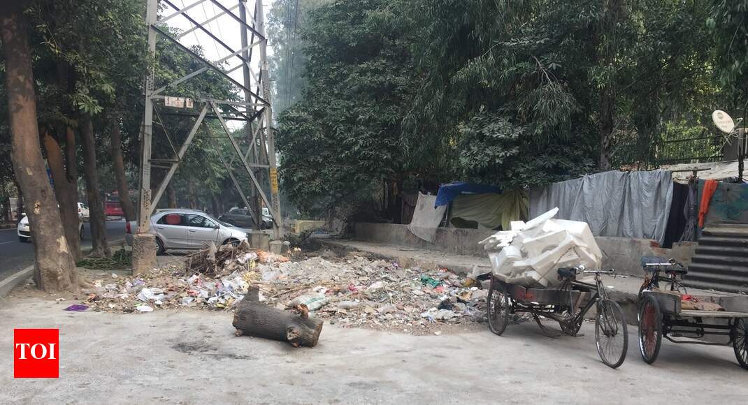 Trash heaps on the road - Times of India